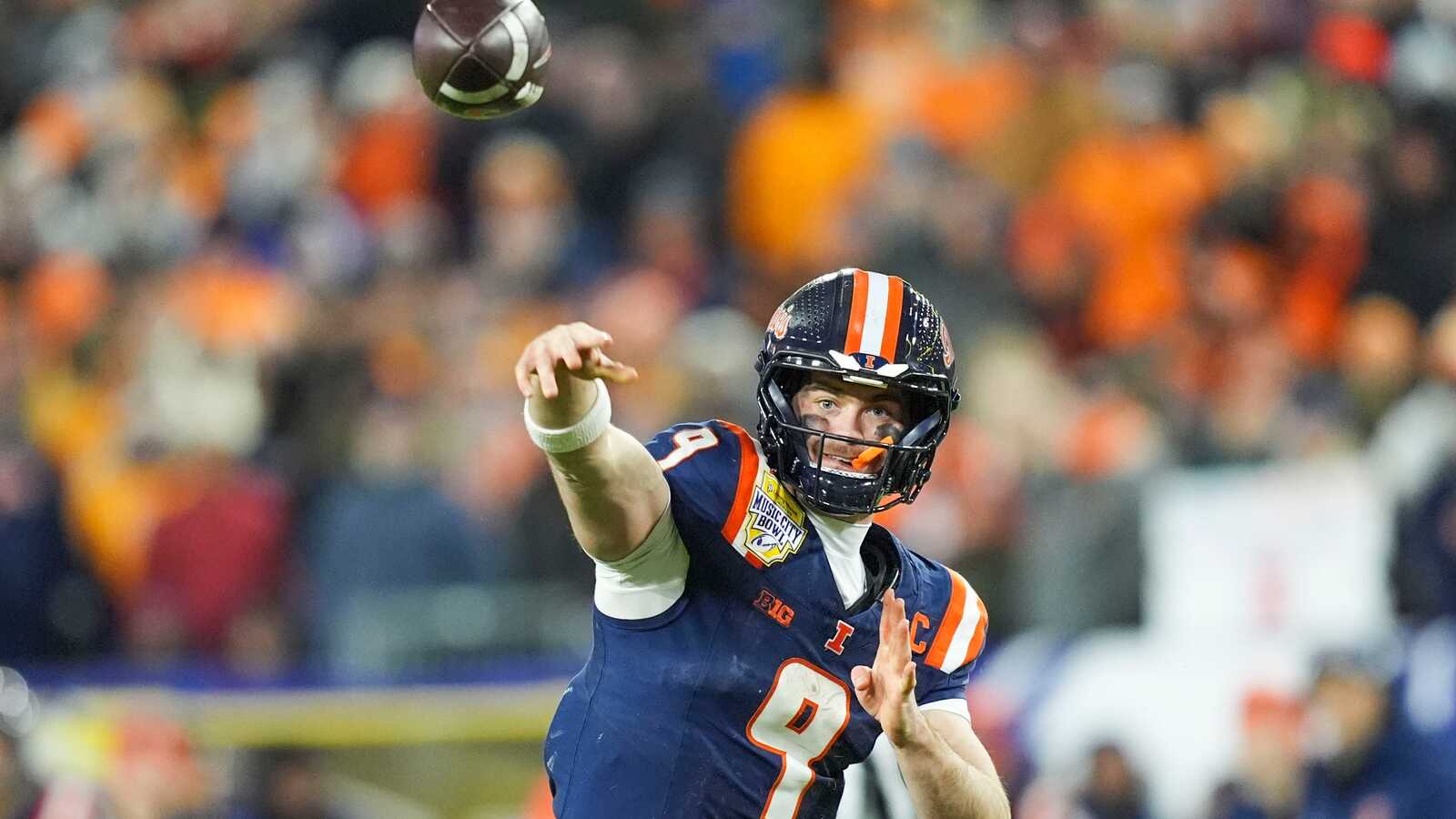 Illinois QB Luke Altmyer runs over a referee during Music City Bowl ...