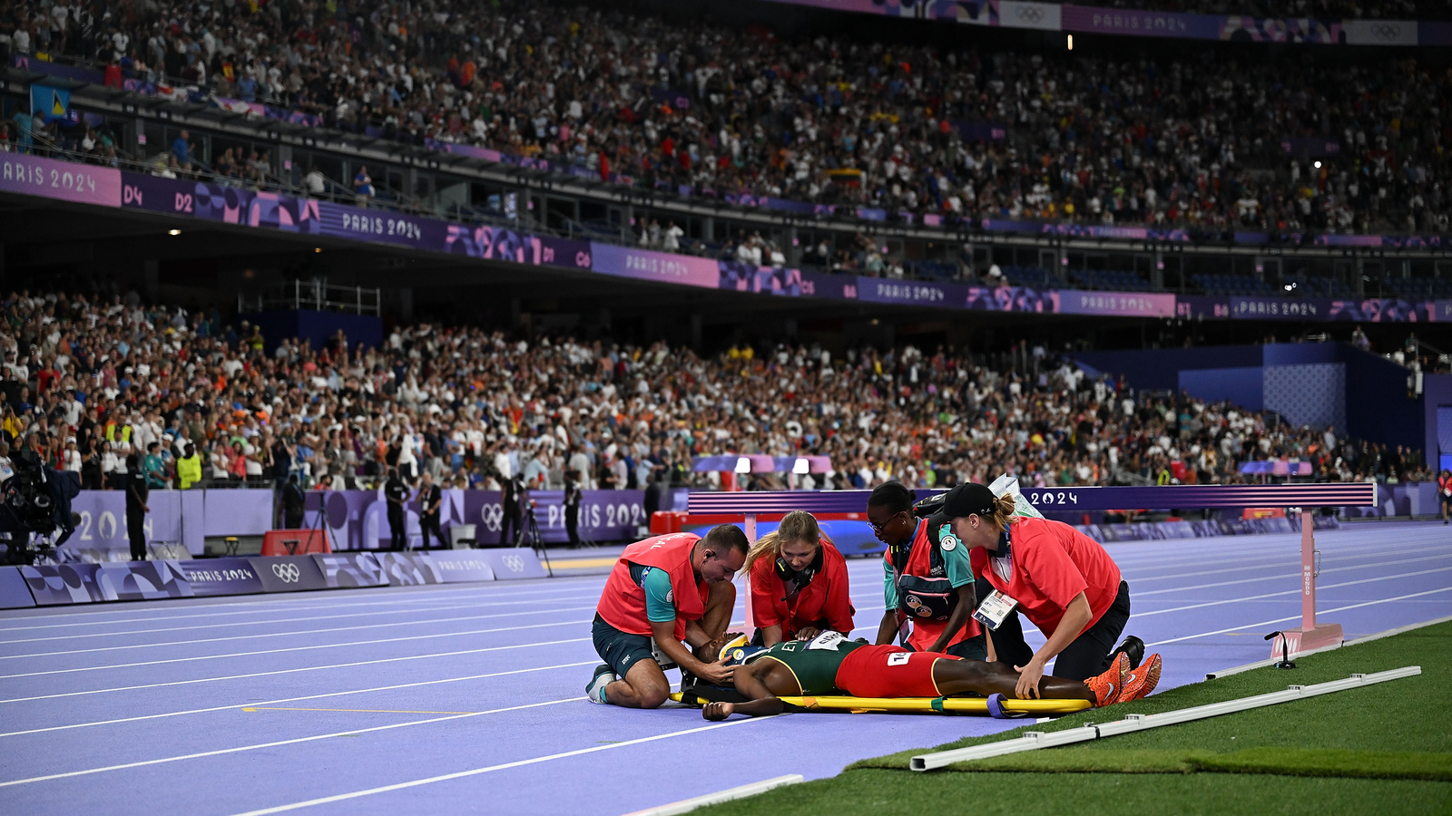 Horrific scene as Olympian and world record runner gets stretchered ...