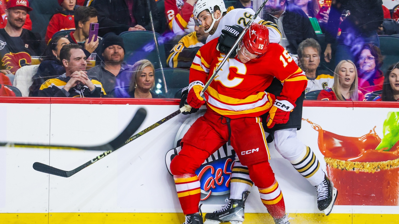 Flames players Dryden Hunt, Walker Duehr and Jarred Tinordi clear ...